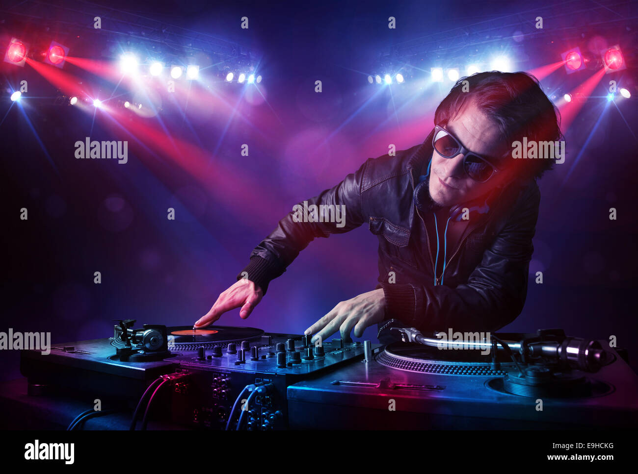 Teenager dj mixing records in front of a crowd on stage Stock Photo - Alamy
