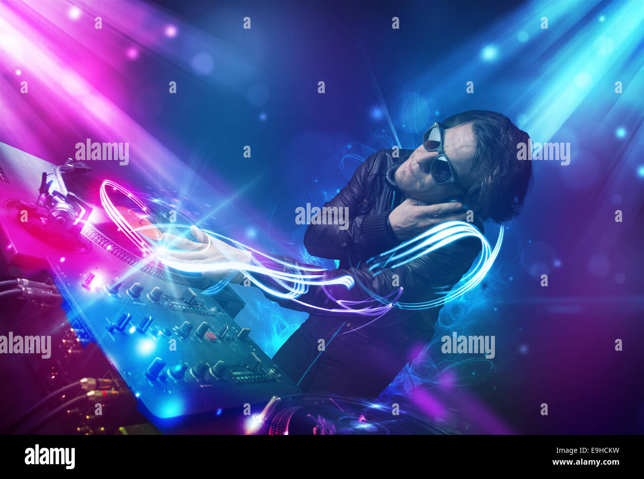 Energetic Dj mixing music with powerful light effects Stock Photo - Alamy
