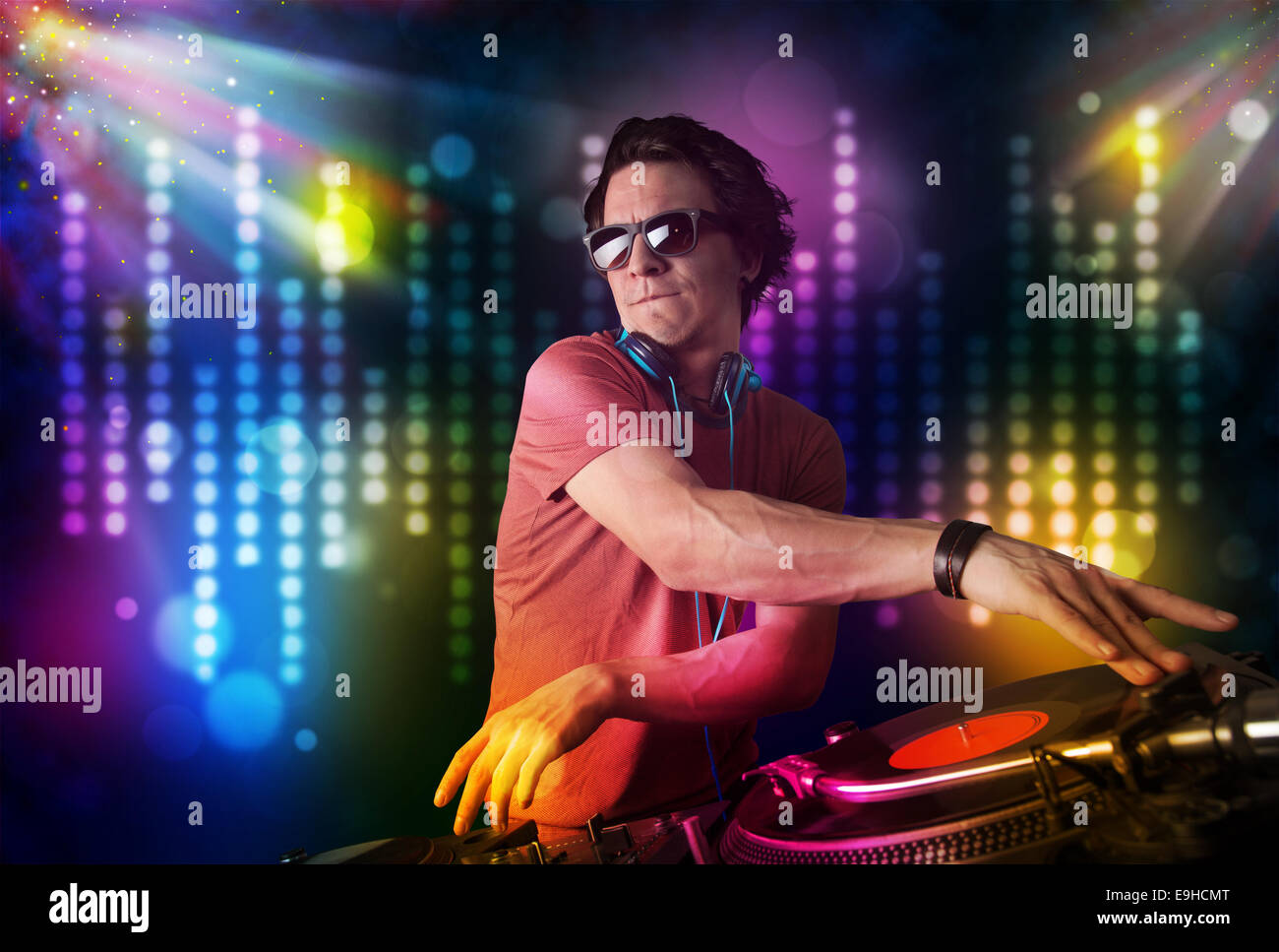 Dj playing songs in a disco with light show Stock Photo - Alamy