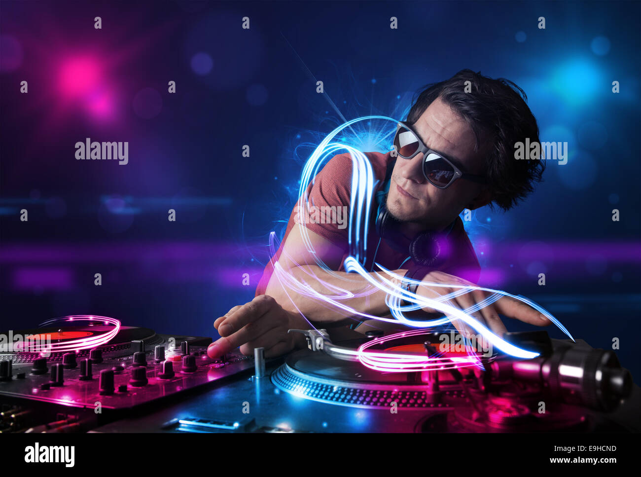 Disc jockey playing music with electro light effects and lights Stock ...