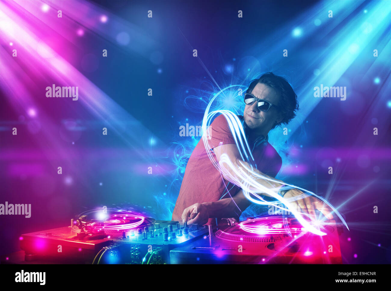 Energetic Dj mixing music with powerful light effects Stock Photo - Alamy