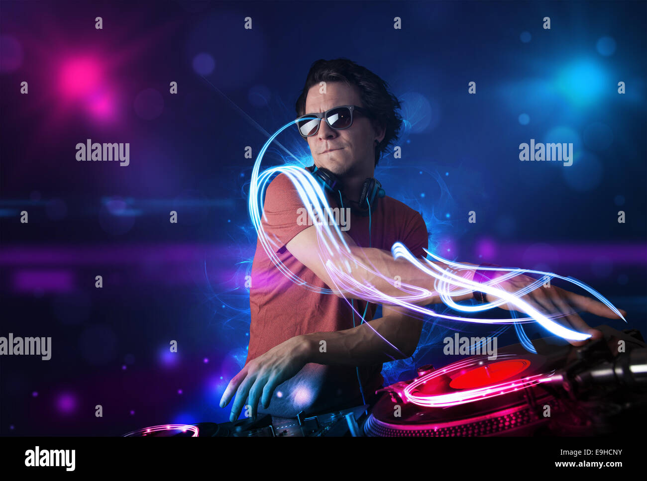 Disc jockey playing music with electro light effects and lights Stock ...