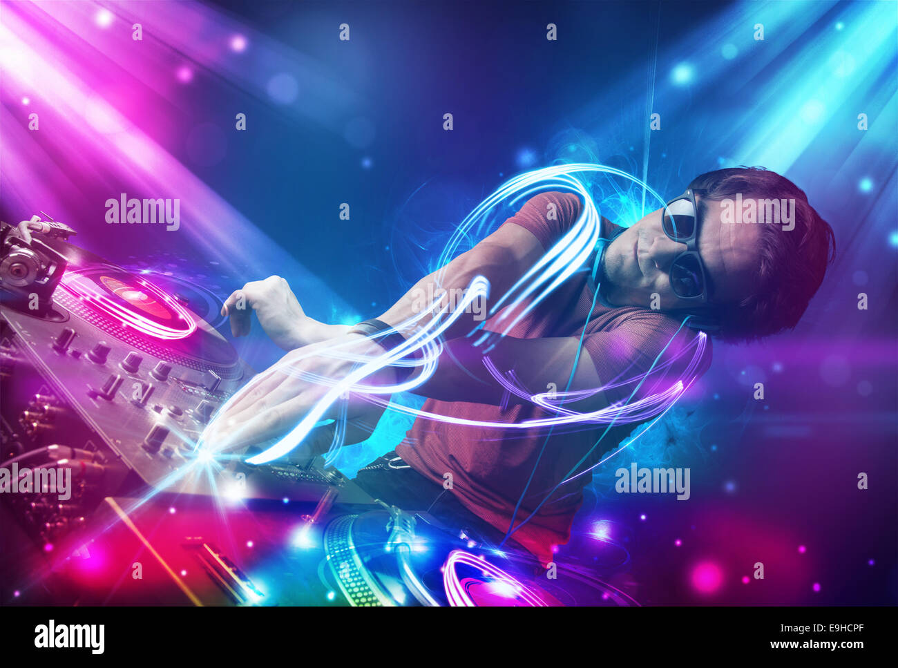 Energetic Dj mixing music with powerful light effects Stock Photo - Alamy