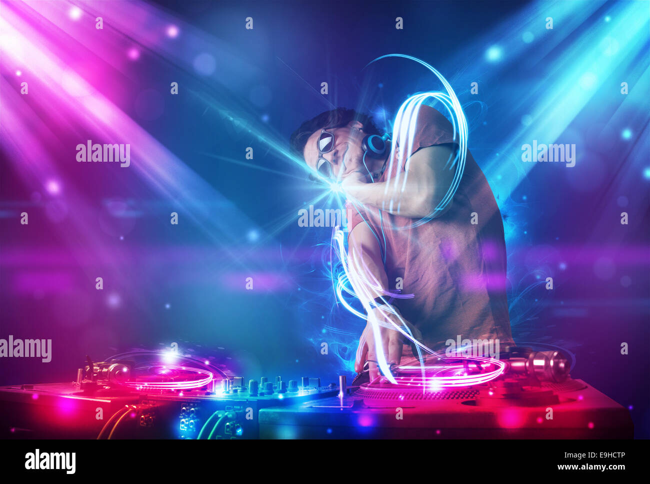 Energetic Dj mixing music with powerful light effects Stock Photo - Alamy