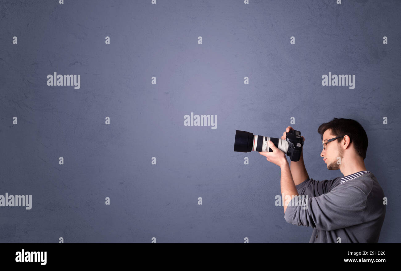 Young photographer shooting images with copyspace area Stock Photo - Alamy