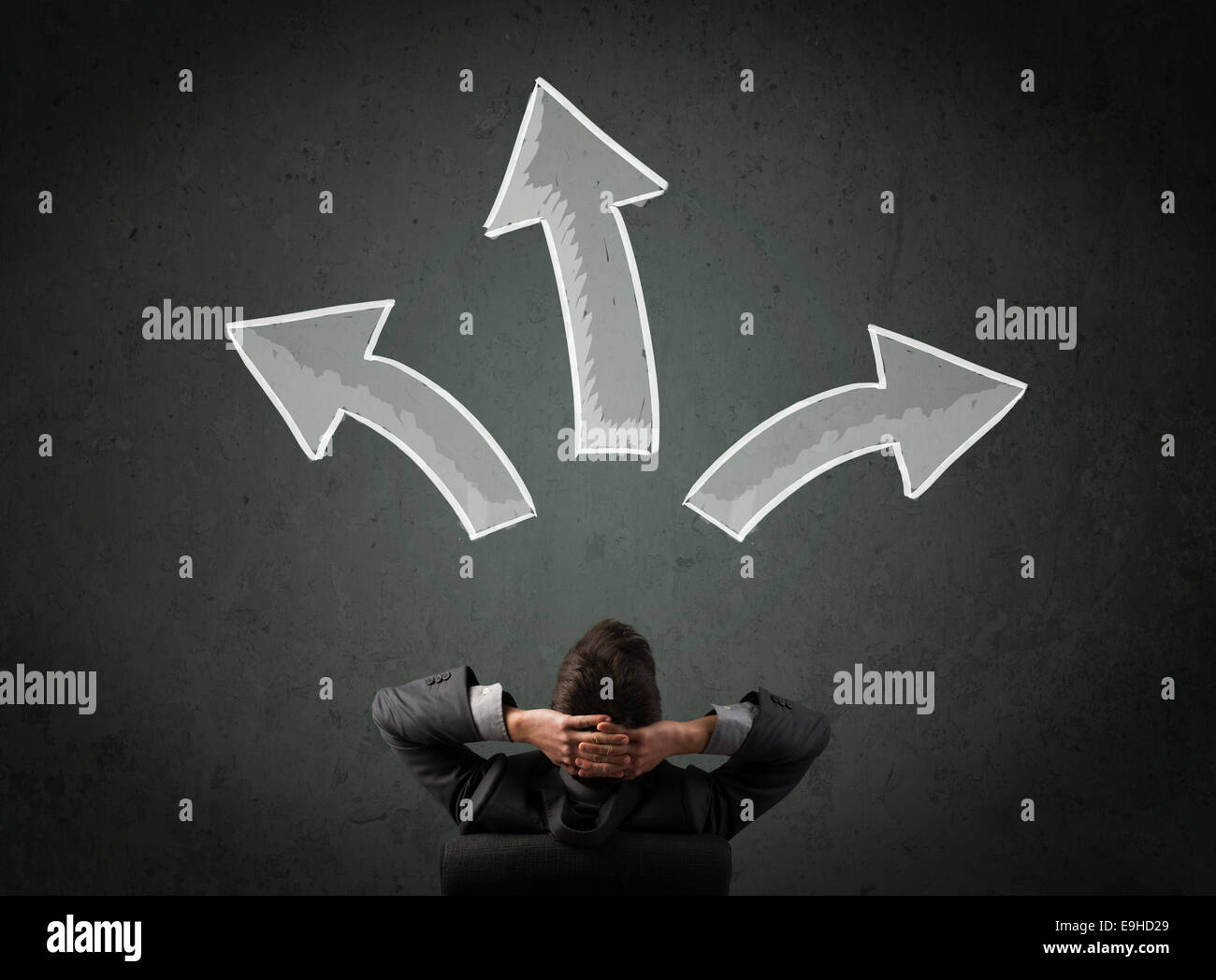 Businessman deciding with arrows above his head Stock Photo - Alamy