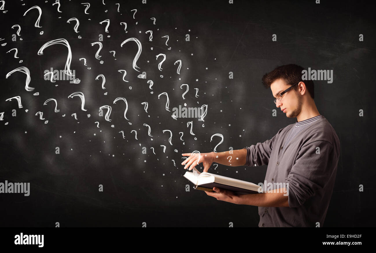 Young man reading a book with question marks coming out from it Stock ...