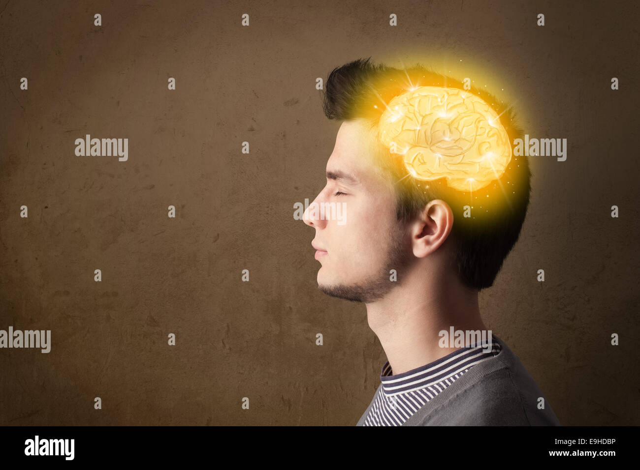 Young man thinking with glowing brain illustration Stock Photo - Alamy