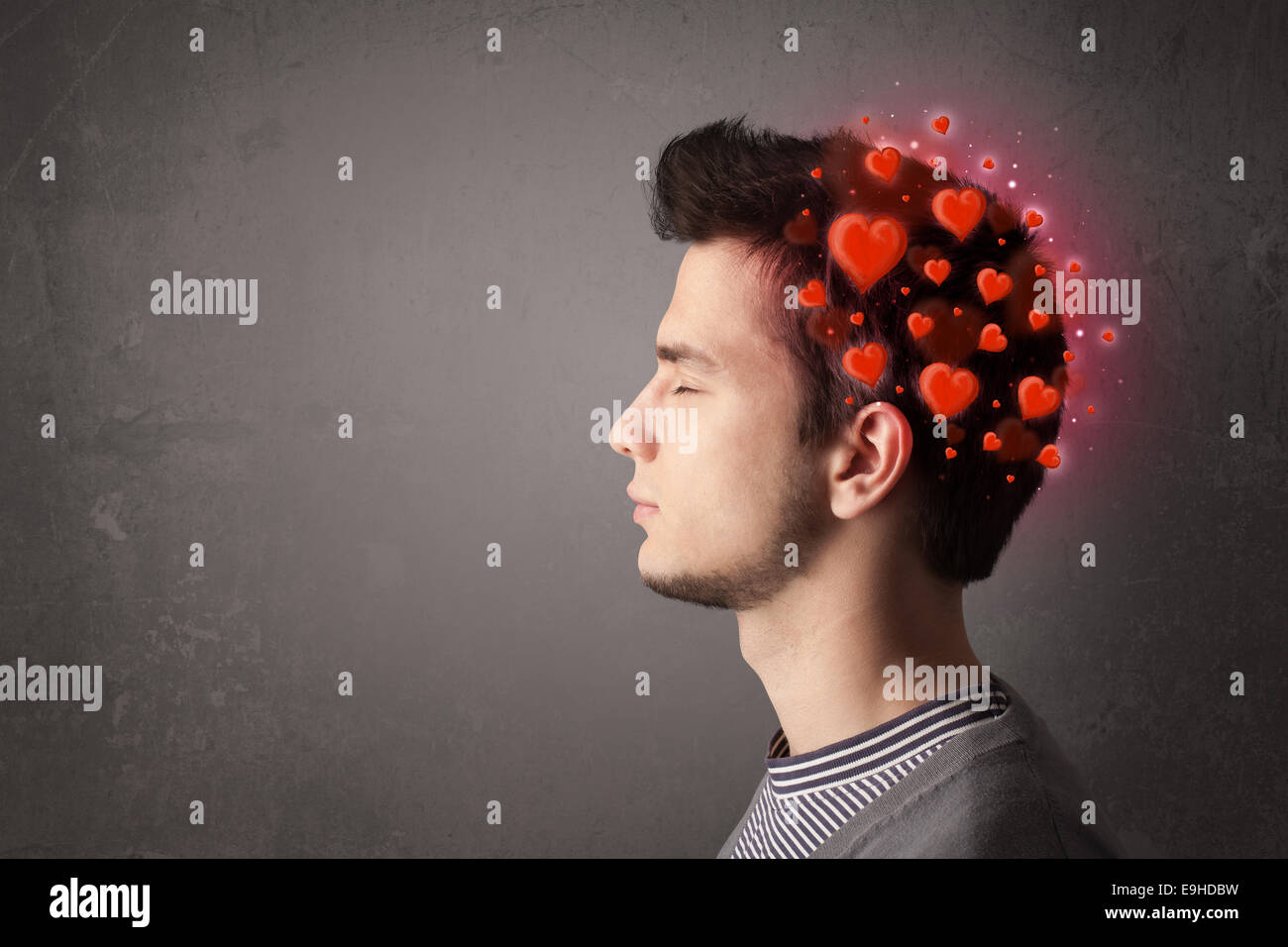 Young person thinking about love with red hearts Stock Photo - Alamy