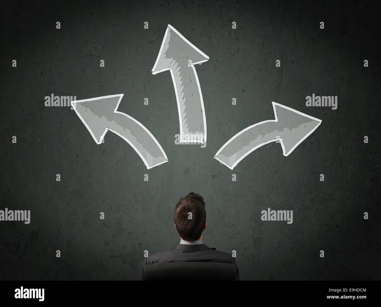 Businessman deciding with arrows above his head Stock Photo - Alamy