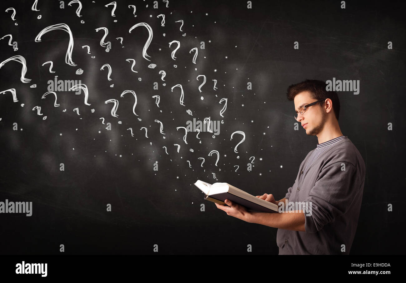 Young man reading a book with question marks coming out from it Stock ...