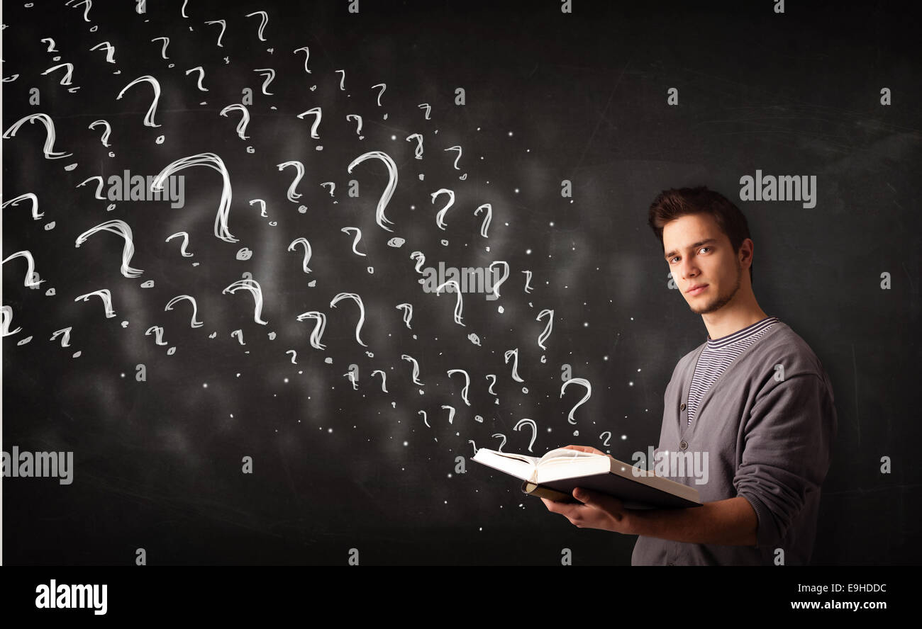 Young man reading a book with question marks coming out from it Stock ...