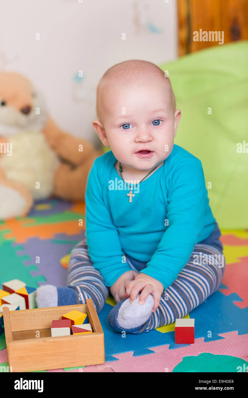 Cute little baby playing with colorful toys at home Stock Photo - Alamy