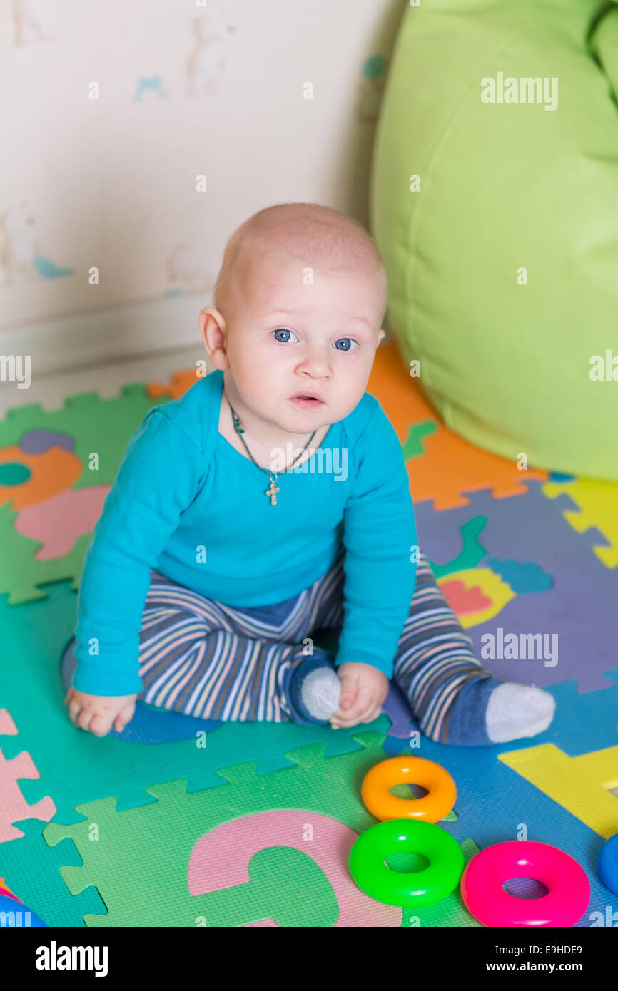 Cute little baby playing with colorful toys at home Stock Photo - Alamy