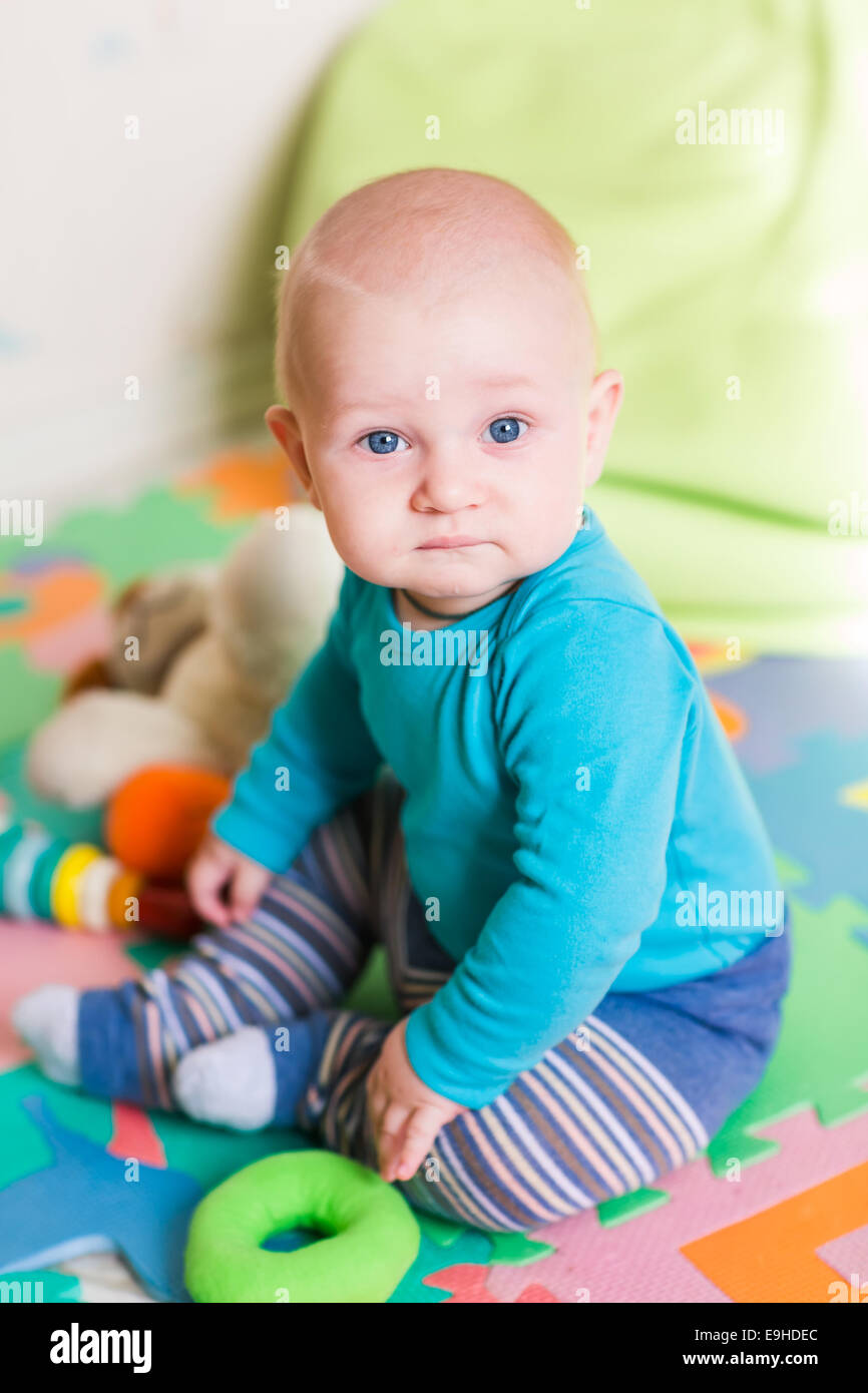 Cute little baby playing with colorful toys at home Stock Photo - Alamy