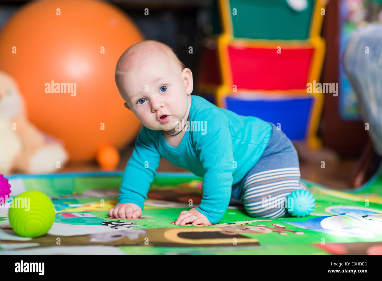 Cute little baby playing with colorful toys at home Stock Photo - Alamy