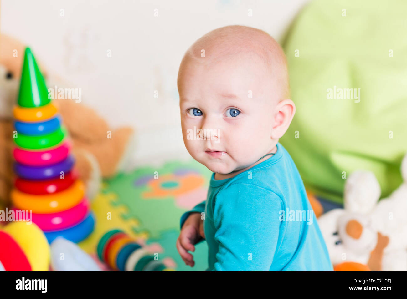 Cute little baby playing with colorful toys at home Stock Photo - Alamy