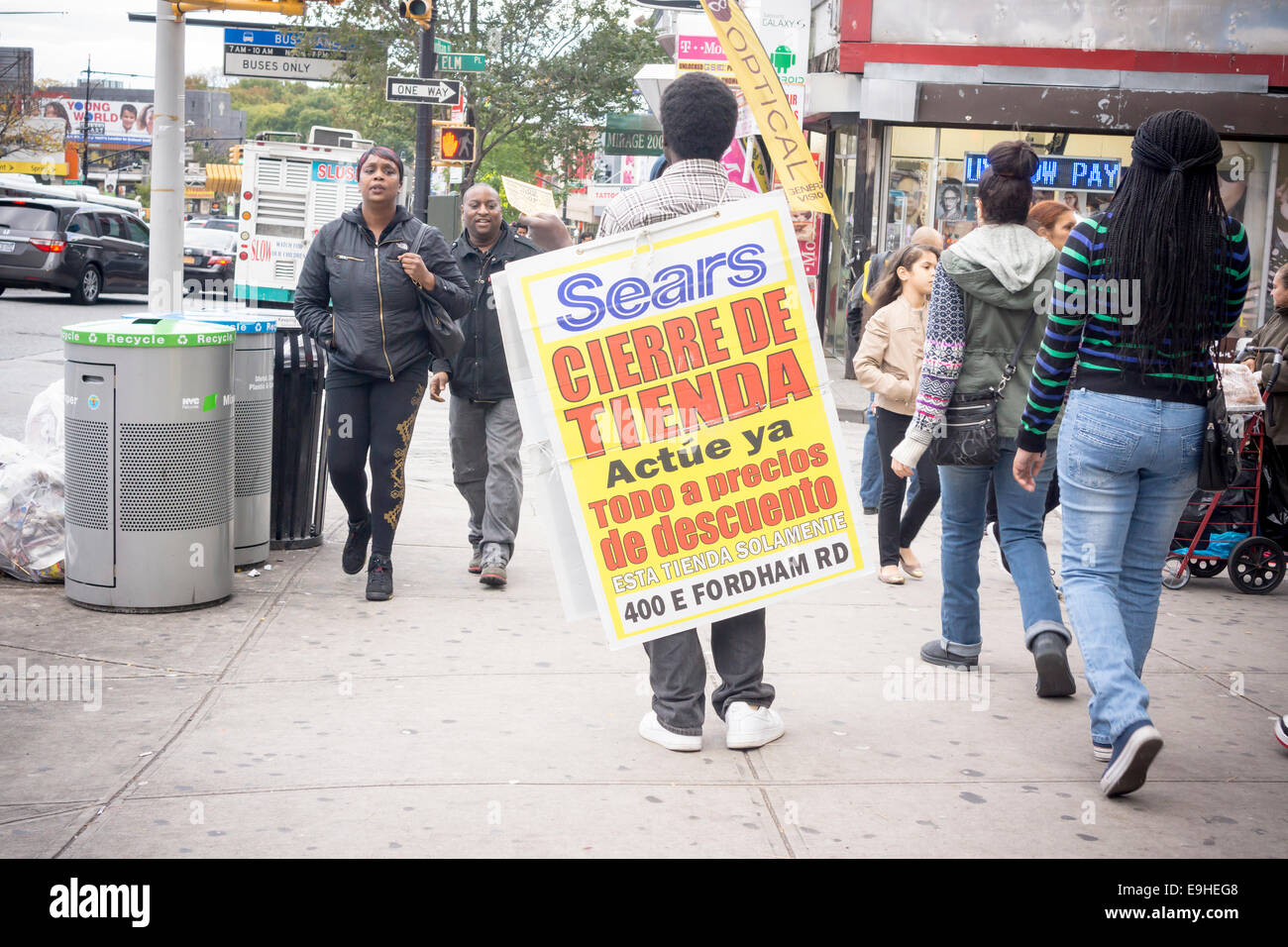 Sandwich board in Spanish advertises the closing Sears store in the New ...