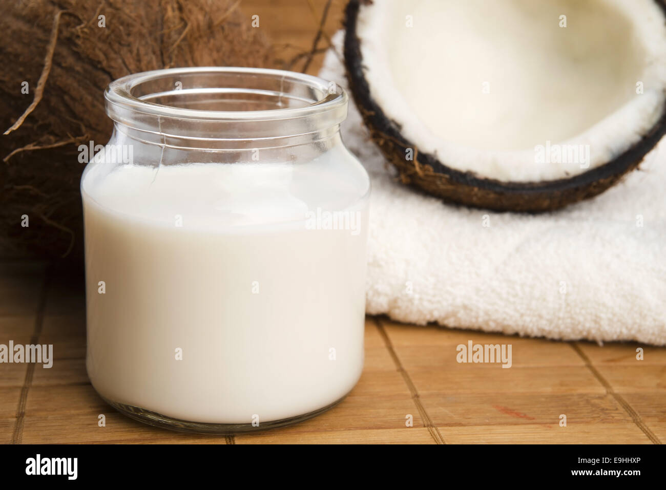coconut fruit with a jar filled with coco milk Stock Photo - Alamy