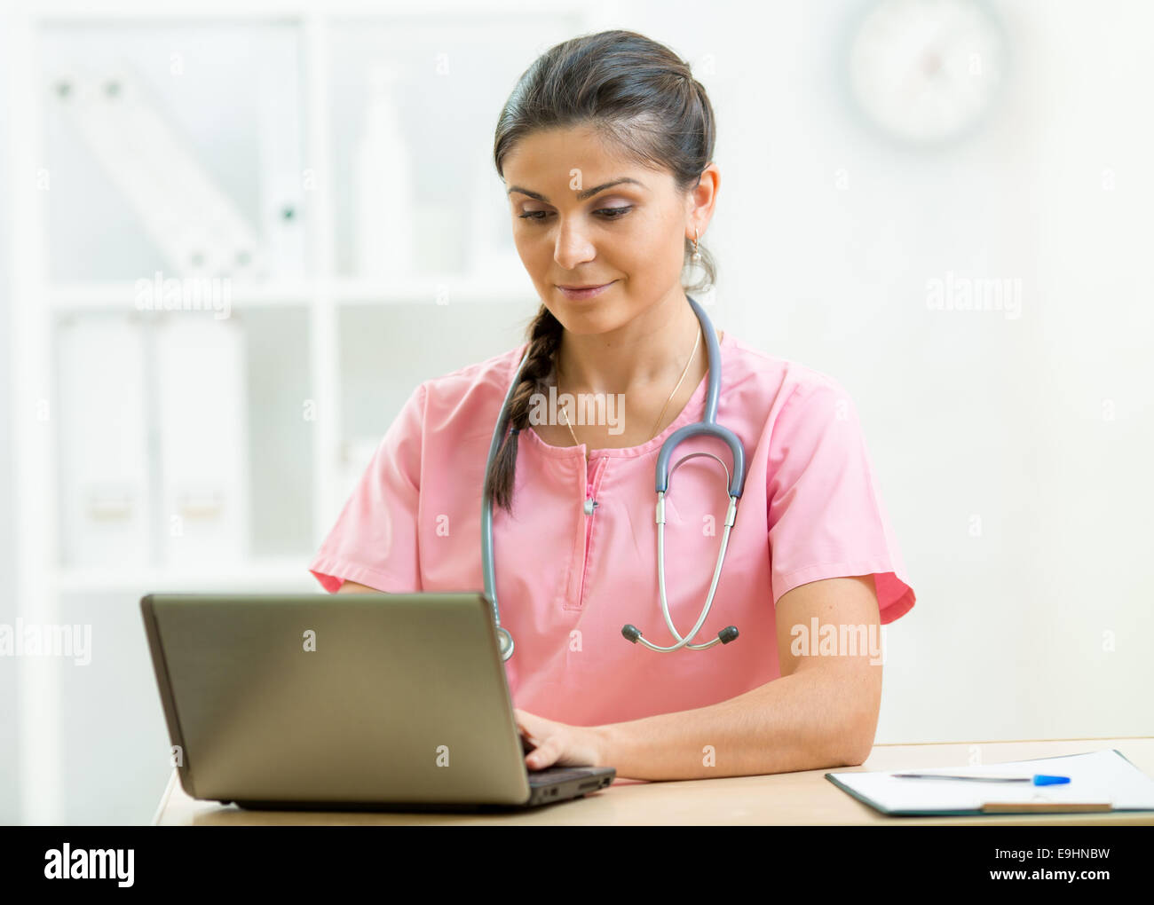smiling physician working in office Stock Photo - Alamy