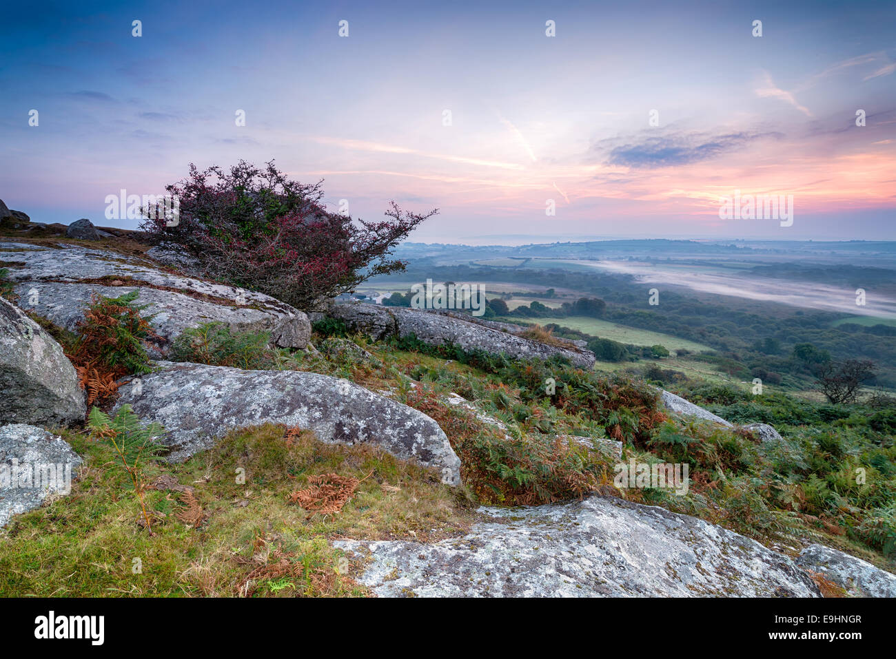 An autumn sunrise over Helman Tor a craggy outcrop of granite and ...