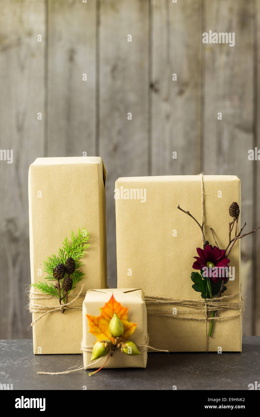 Gifts wrapped in kraft paper, tied with twine and embellished with ...