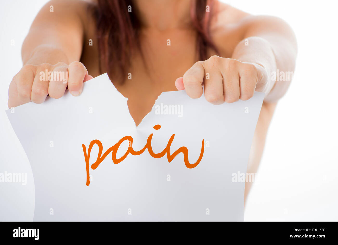 woman tearing sheet of paper with the word pain Stock Photo - Alamy