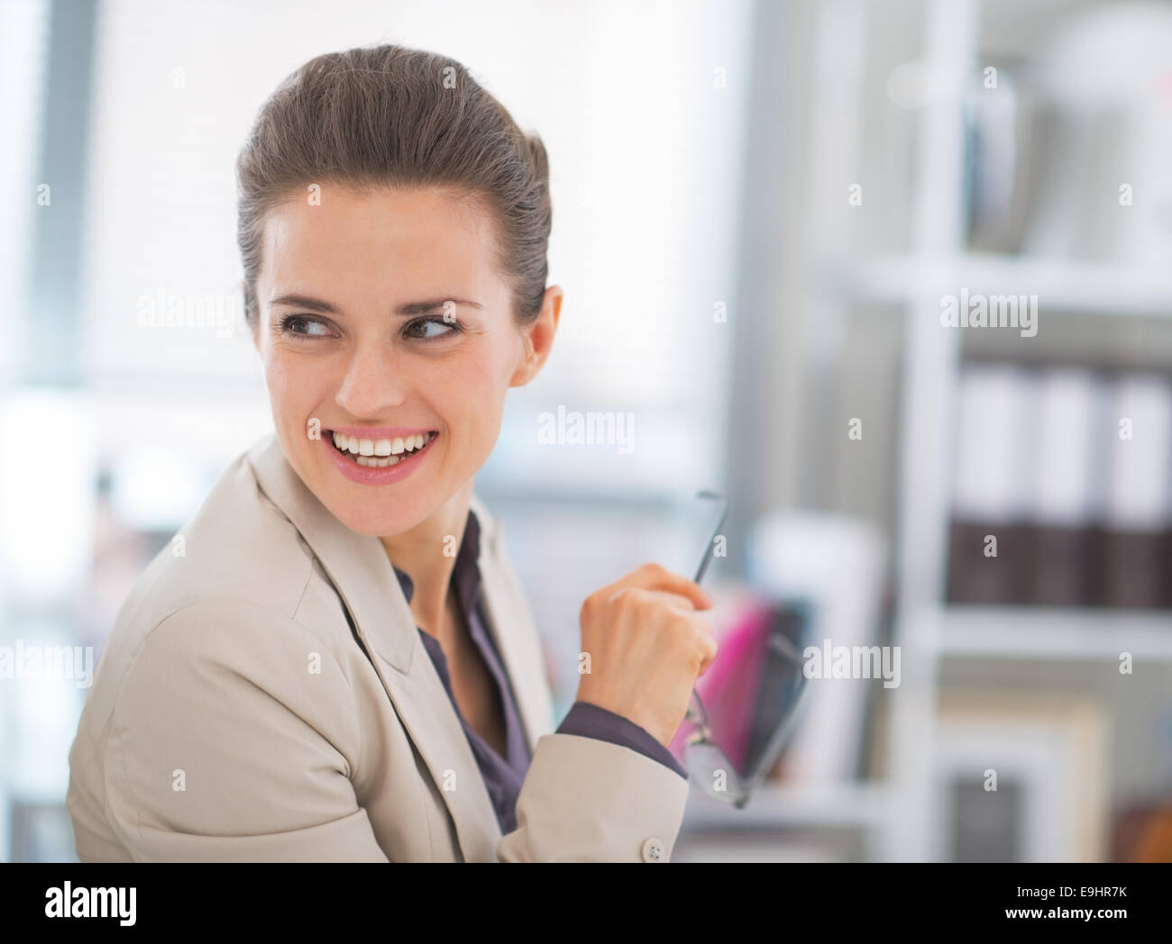 Happy business woman with eyeglasses in office Stock Photo - Alamy