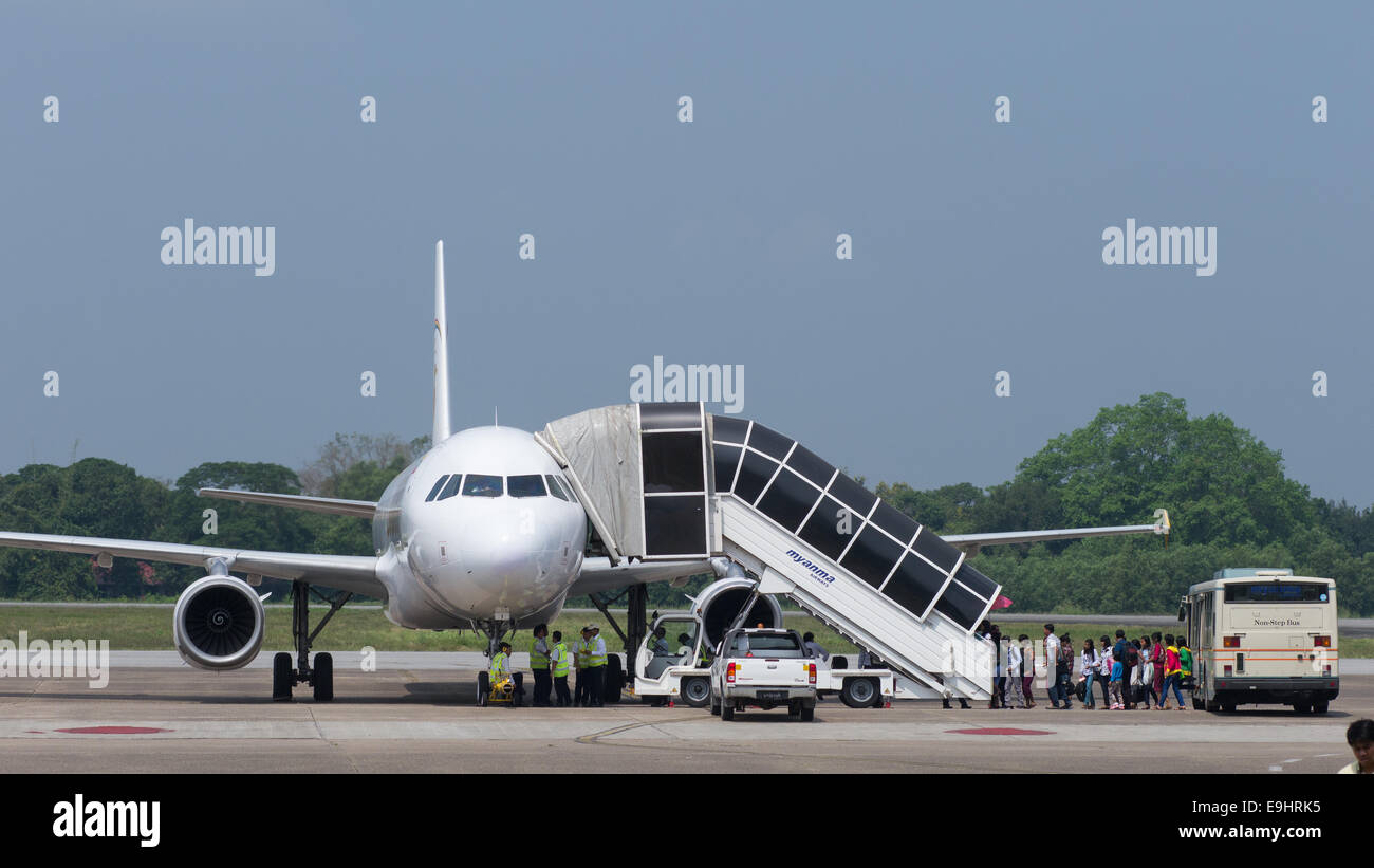 Passengers boarding an Airbus A320-200 from Golden Myanmar Airlines at ...