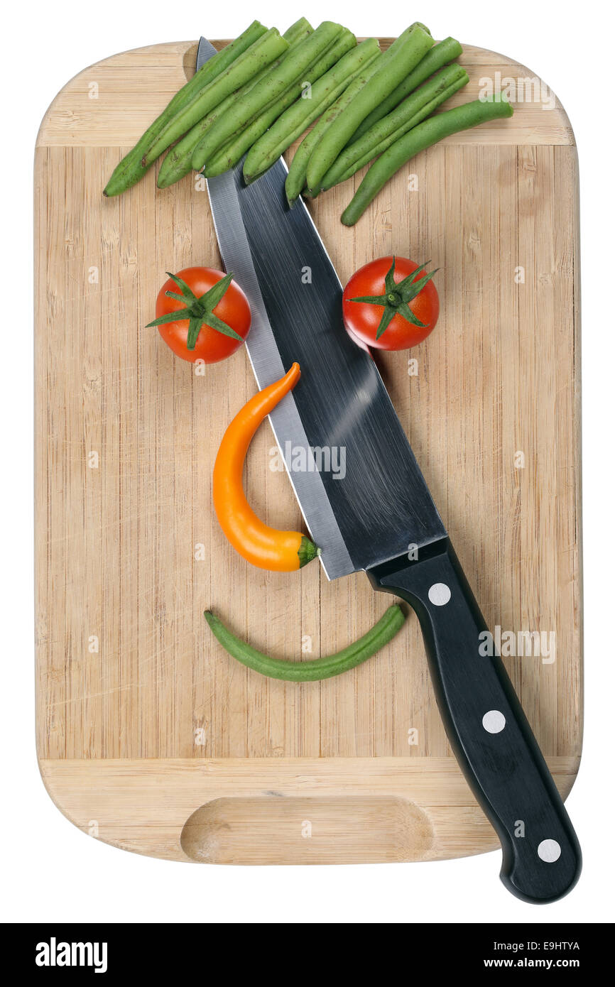 Slicing food with knife smiling vegetables face on cutting board ...