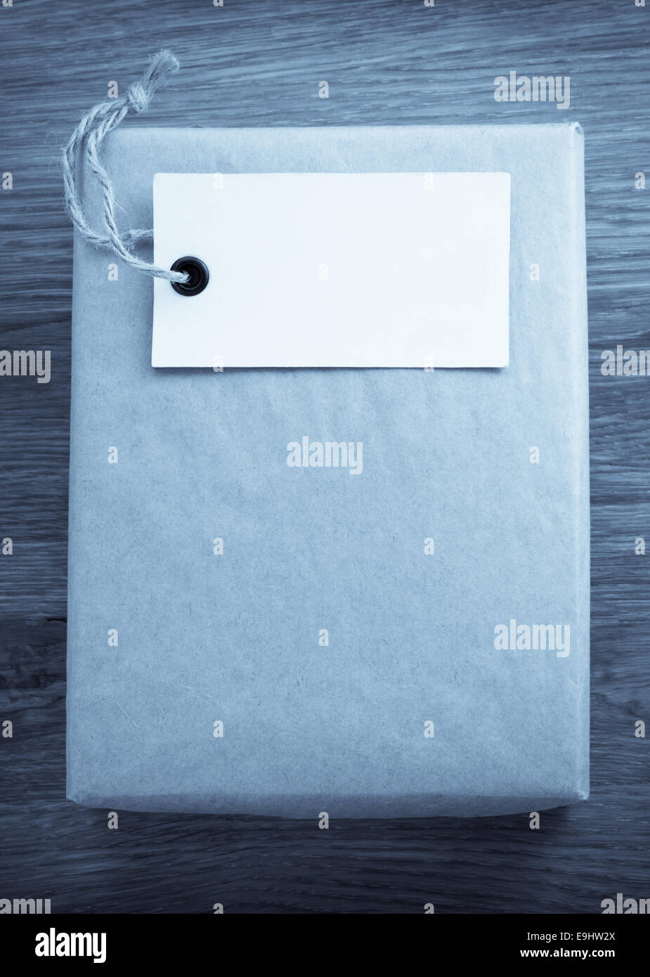 paper parcel wrapped tied with price tag on wooden background Stock ...