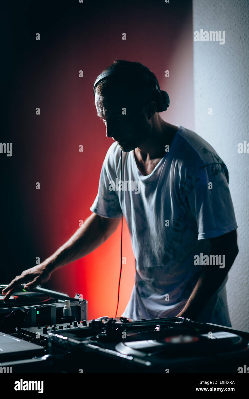 Silhouette of dj at work in night club. Shallow depth of field Stock ...