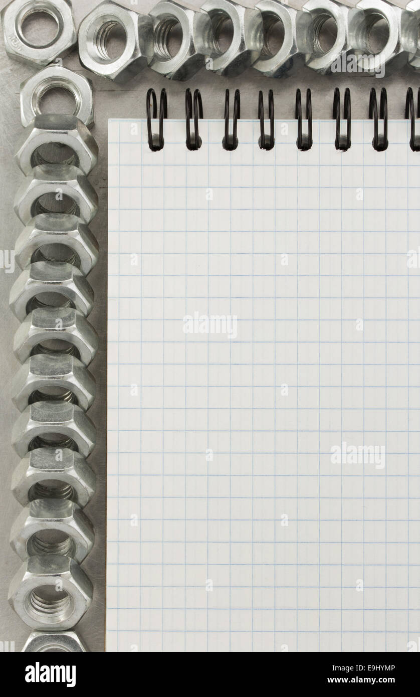 nuts tool and notebook at metal background Stock Photo - Alamy