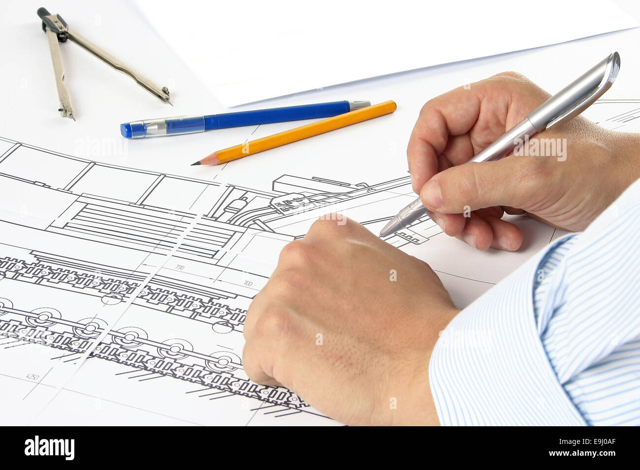 Compasses, picture, pencil and hand Stock Photo - Alamy