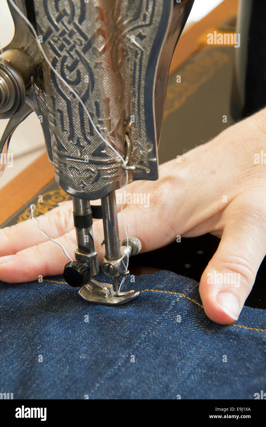 Detail of hand and vintage sewing machine Stock Photo - Alamy
