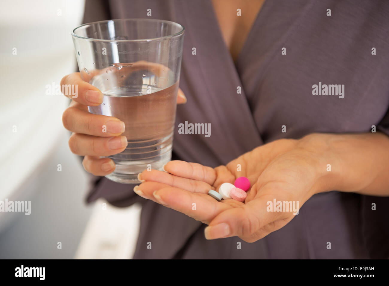 Closeup on young woman with pills Stock Photo - Alamy
