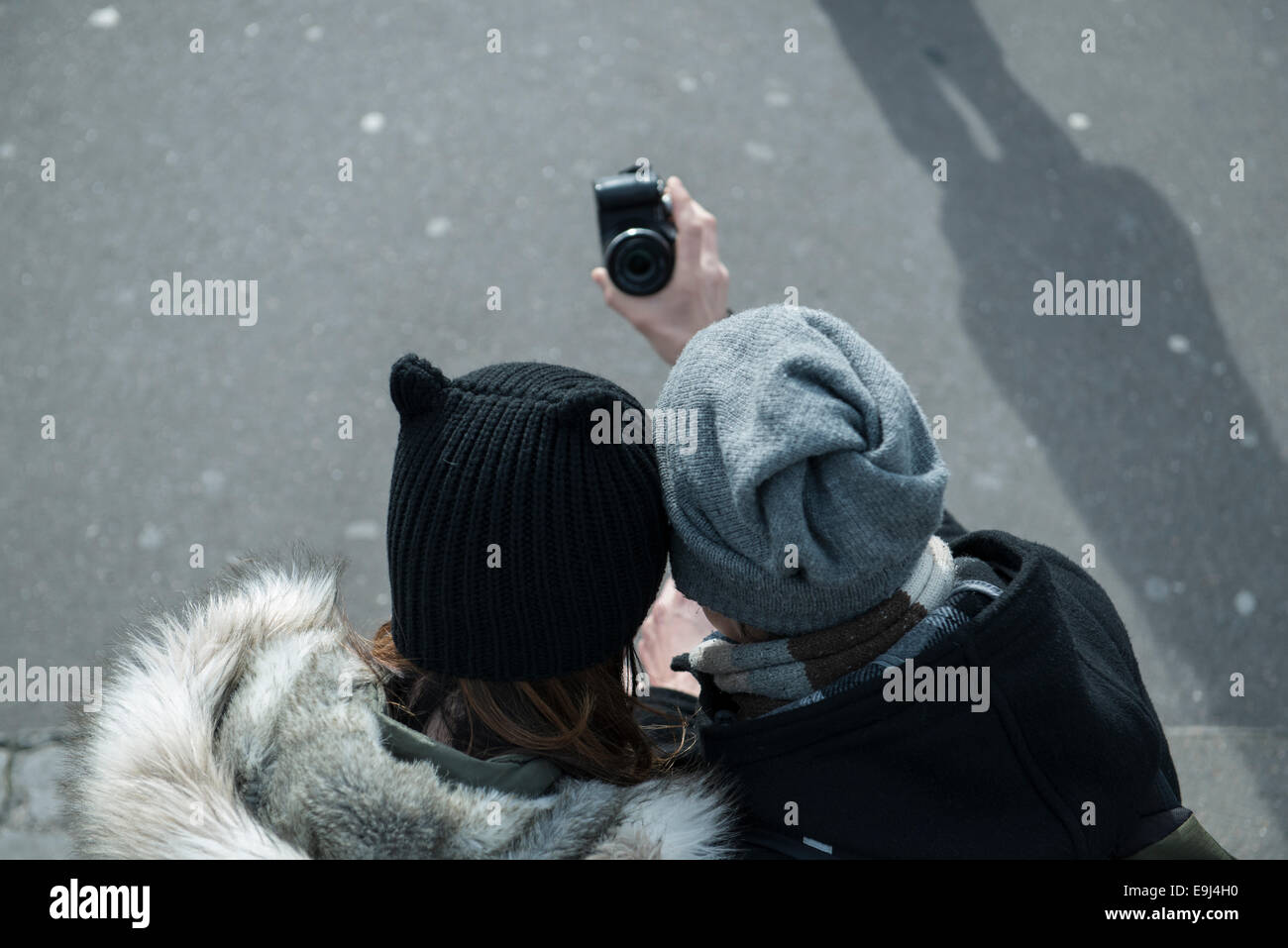two people take a selfie / self portrait with a camera pointed towards ...