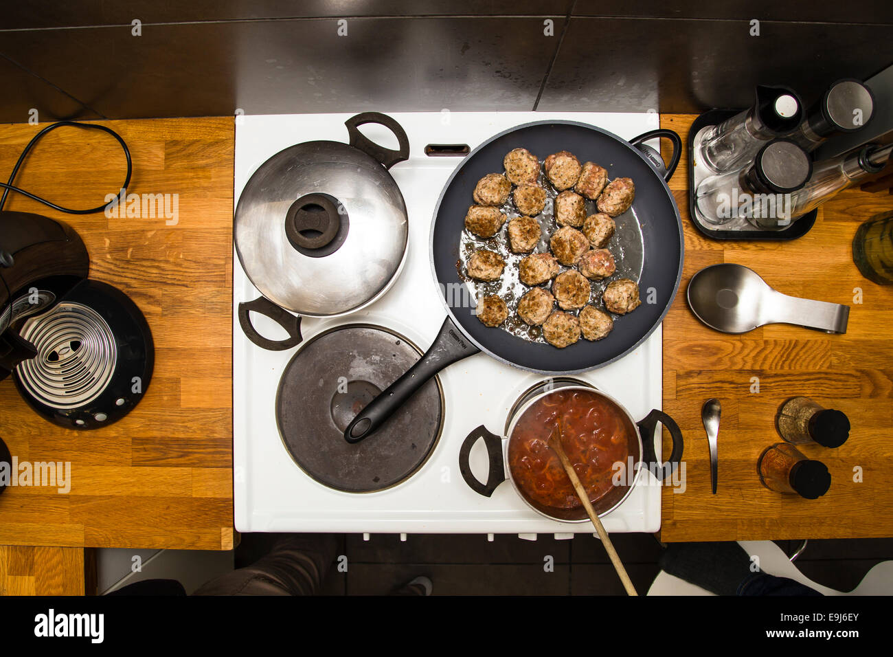 Woman preparing dinner in a home kitchen, real life situation Stock ...