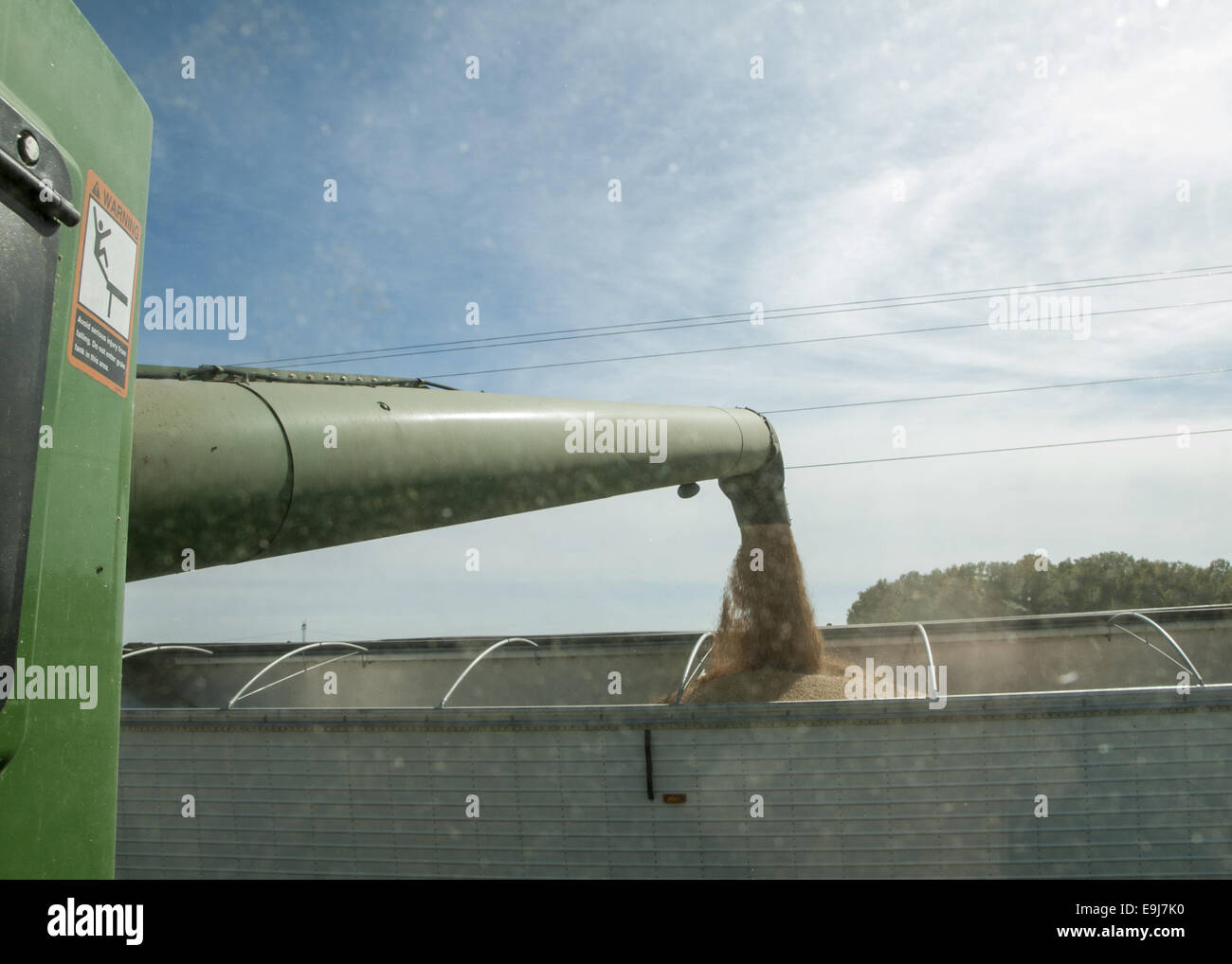 John Deere S670 combine dumping hopper grain into the trailer of a semi ...
