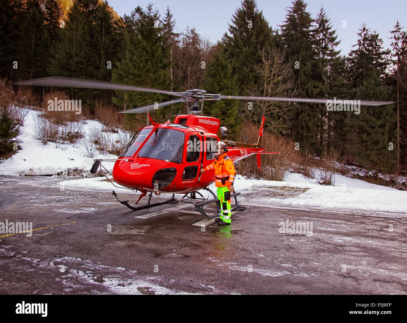 GSTEIGWILER-INTERLAKEN, SWITZERLAND - DECEMBER 31, Red helicopter and ...