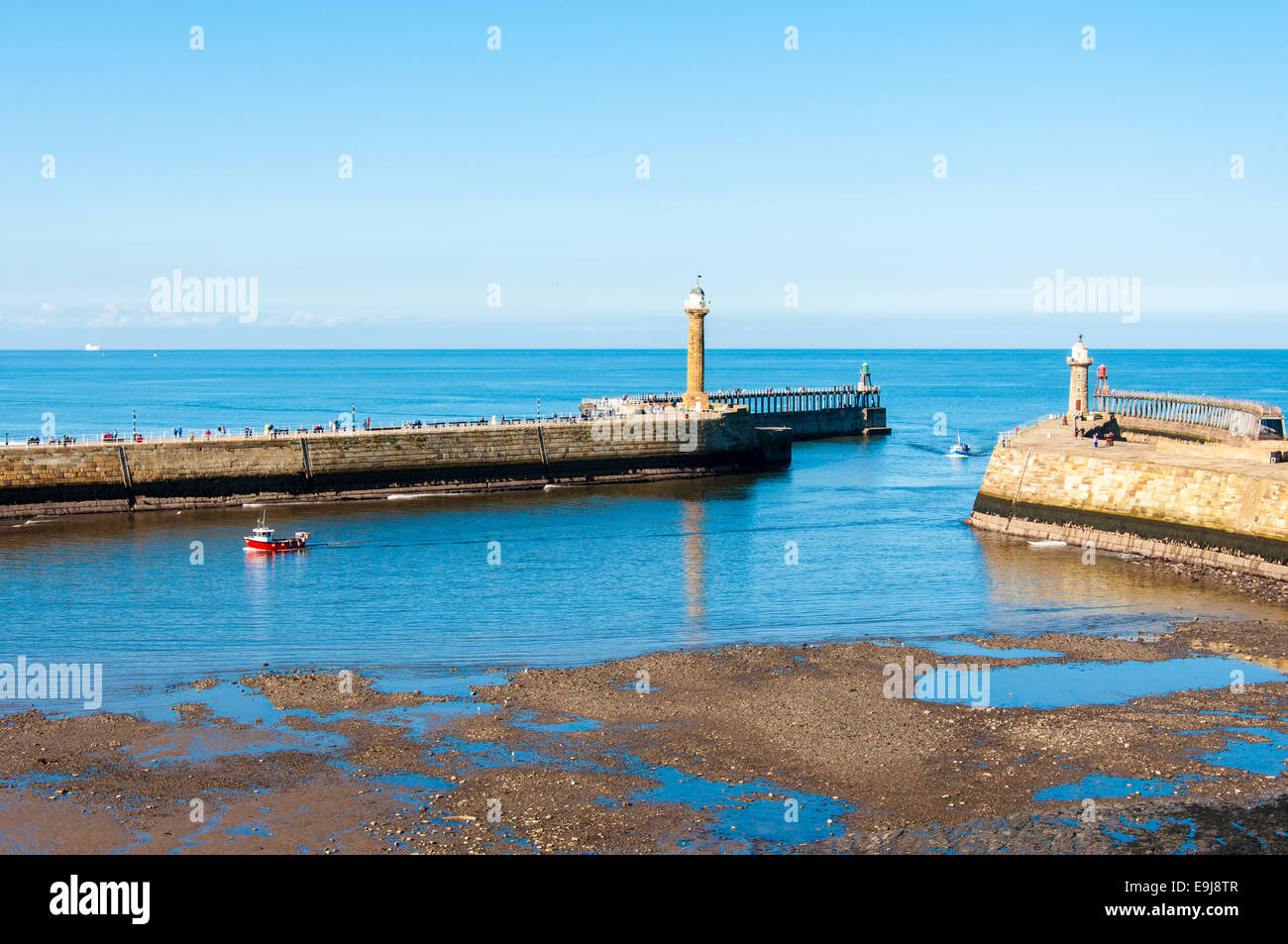 Scenic view of Whitby Pier in sunny autumn day, North Yorkshire, UK ...
