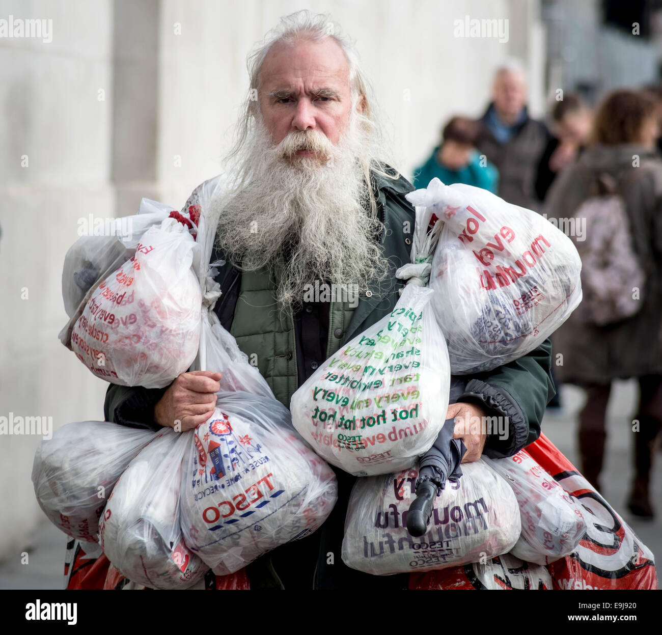 A homeless man with bagged possessions walks through London's Trafalgar ...