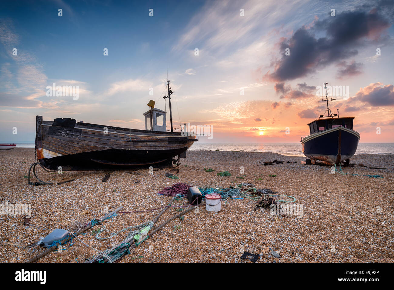 Fishing boats on a Kent pebble beach at sunrise Stock Photo - Alamy