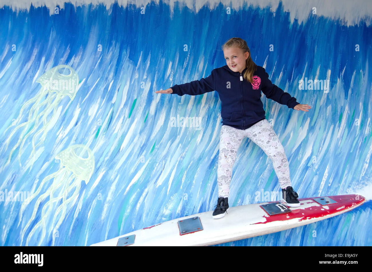 Young Girl standing on a model surfboard, Bournemouth, Dorset, UK Stock ...