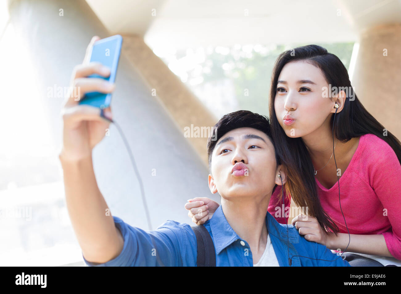 Young couple taking self portrait with a smart phone Stock Photo - Alamy