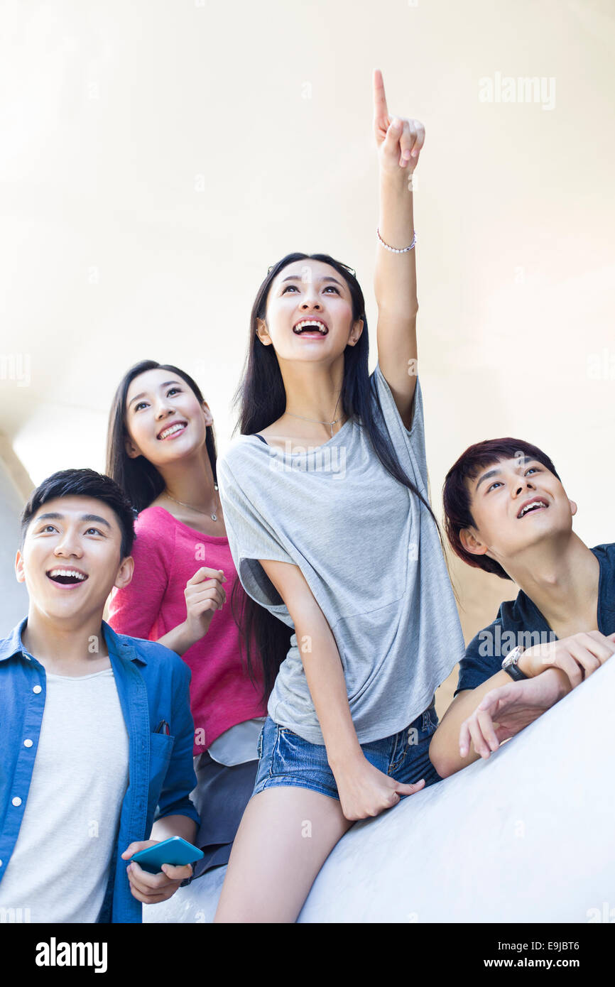 Looking away standing smiling hand raised hi-res stock photography and ...