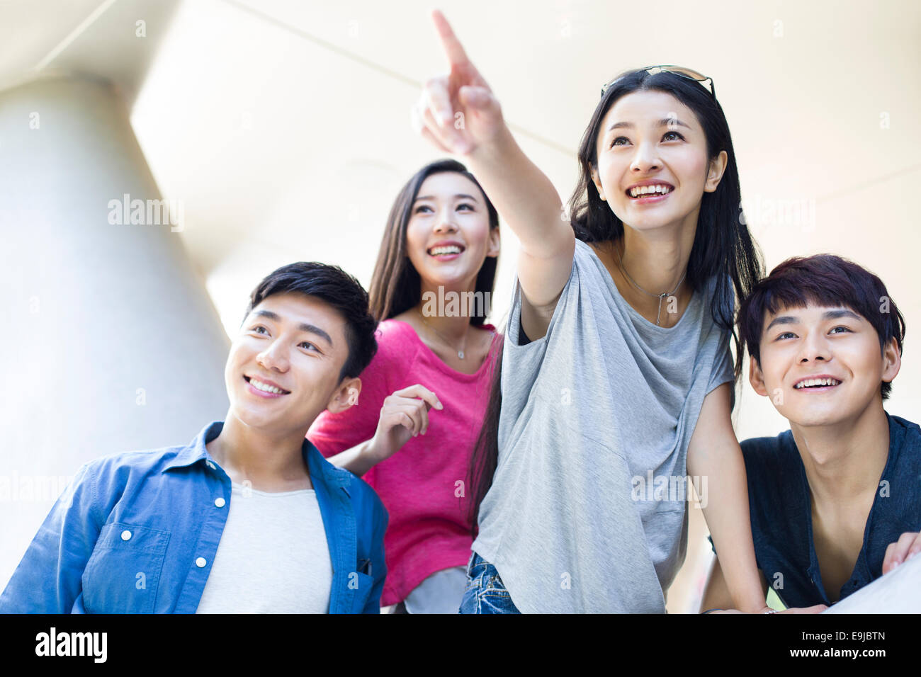 Standing holding looking away smiling hand raised hi-res stock ...