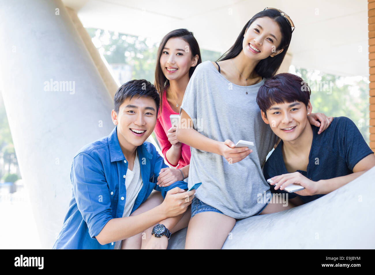 Portrait of young friends with smart phones Stock Photo - Alamy