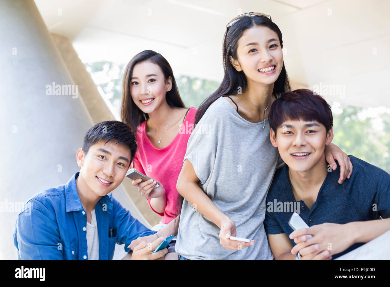 Portrait of young friends with smart phones Stock Photo - Alamy