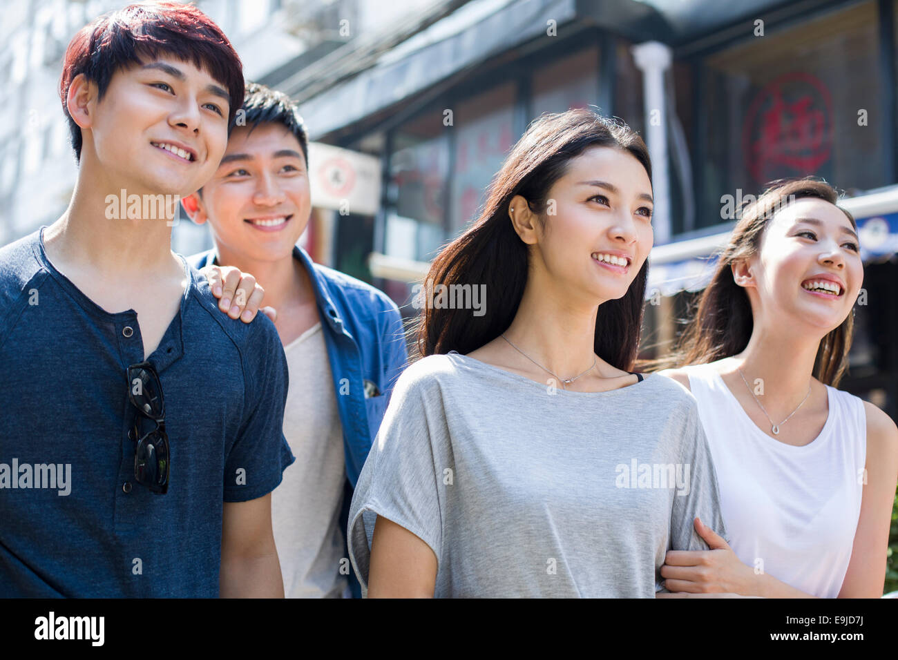 College friends walking on street hi-res stock photography and images ...